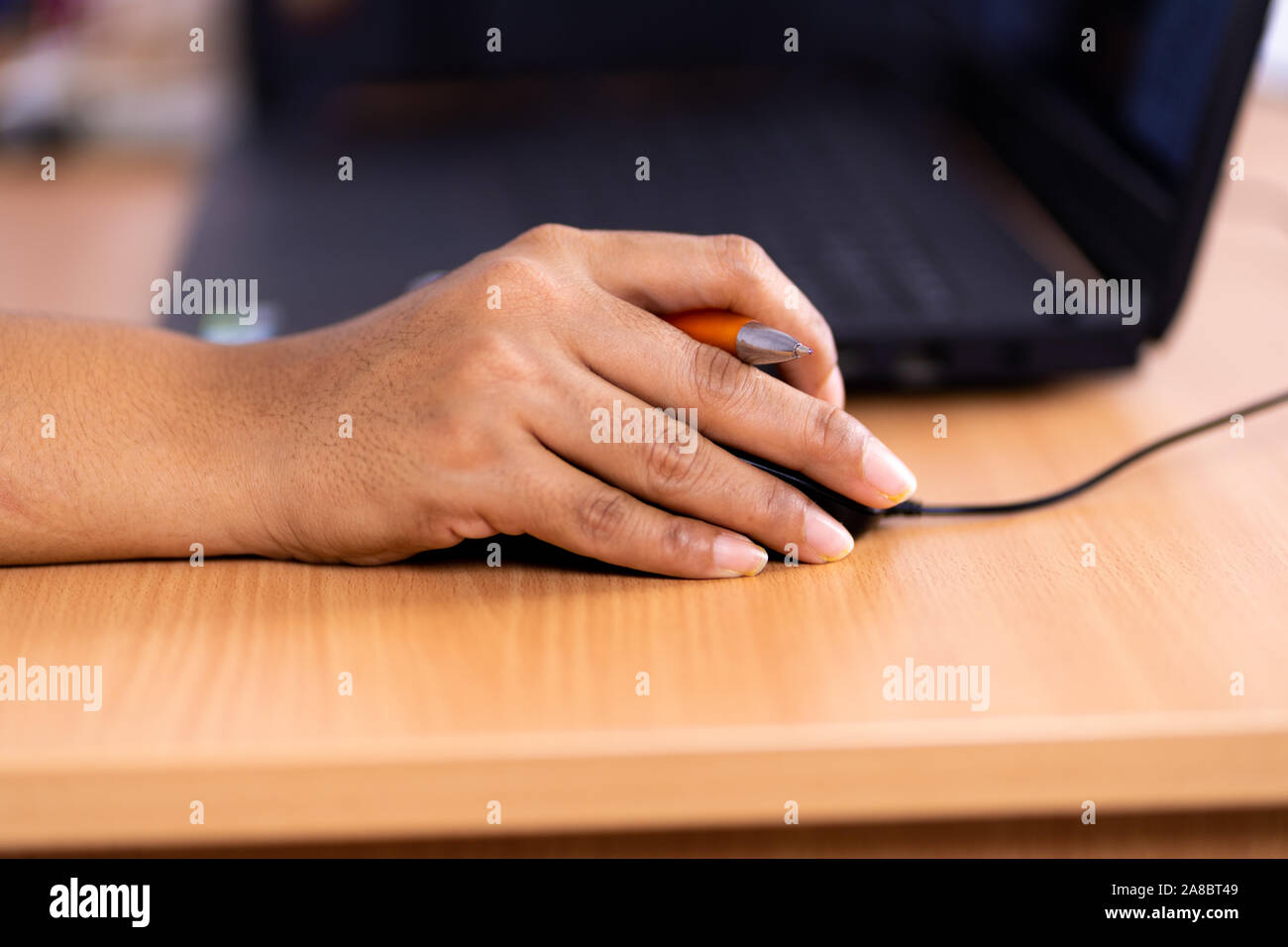 Female hand holding computer mouse Stock Photo - Alamy