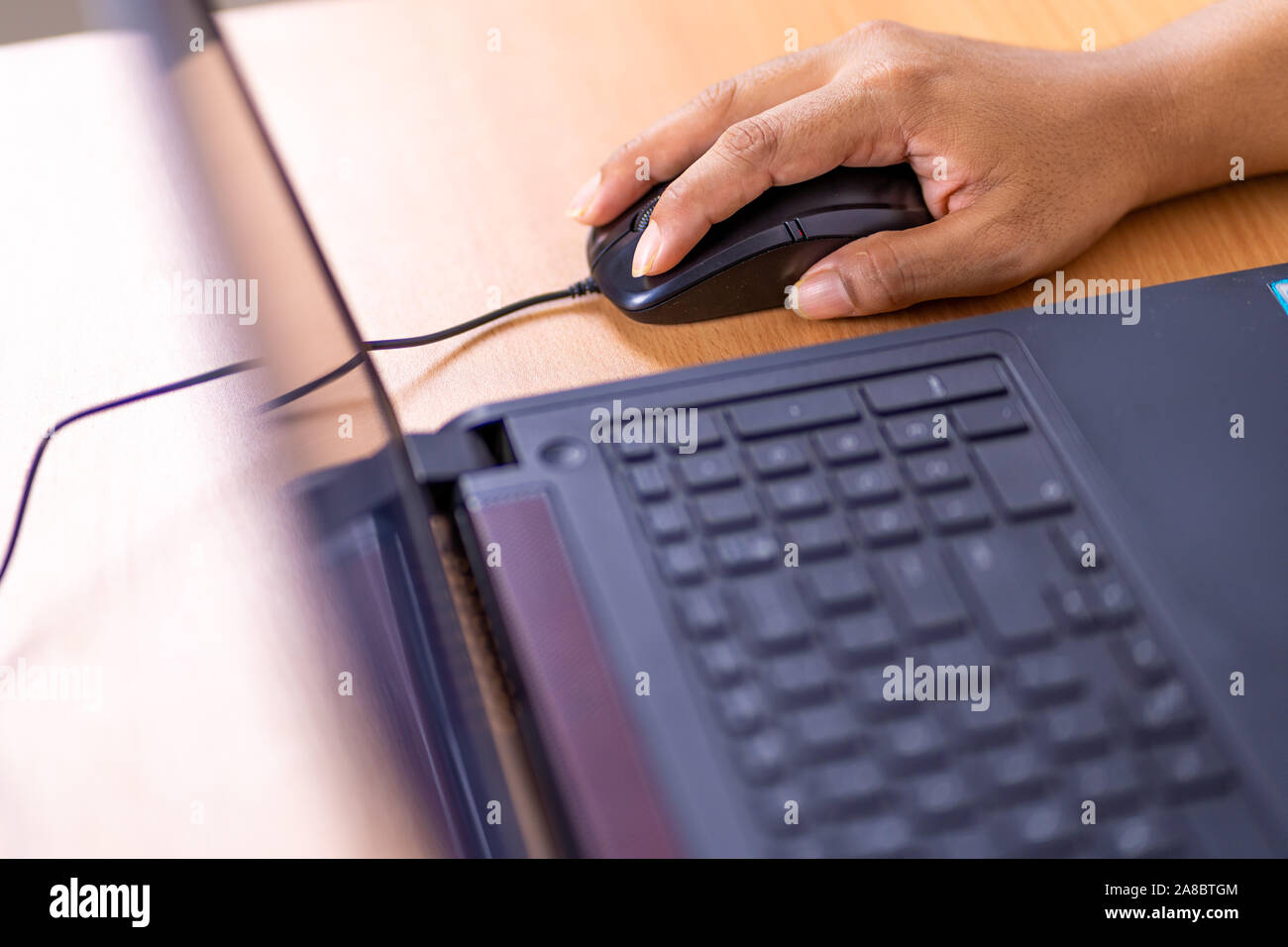 Female hand holding computer mouse Stock Photo - Alamy