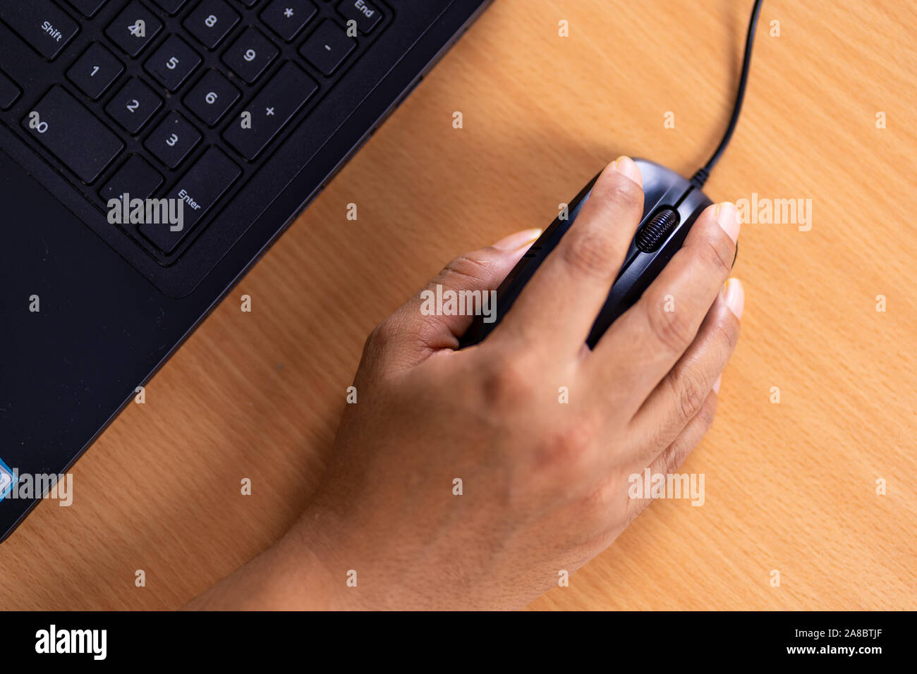 Top view of hands holding mouse on table Stock Photo - Alamy