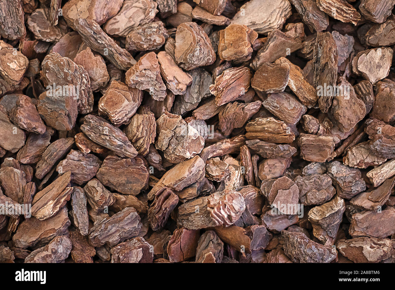 Shredded texture pieces of natural tree bark close-up. Chopped eco wood ...