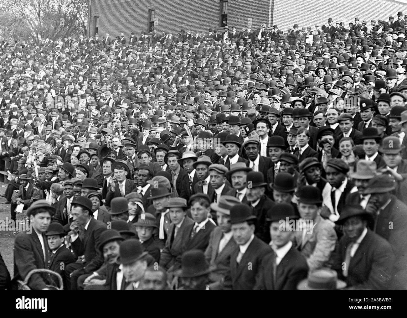 Crowd watching a baseball game from the bleachers of a ballpark ca ...