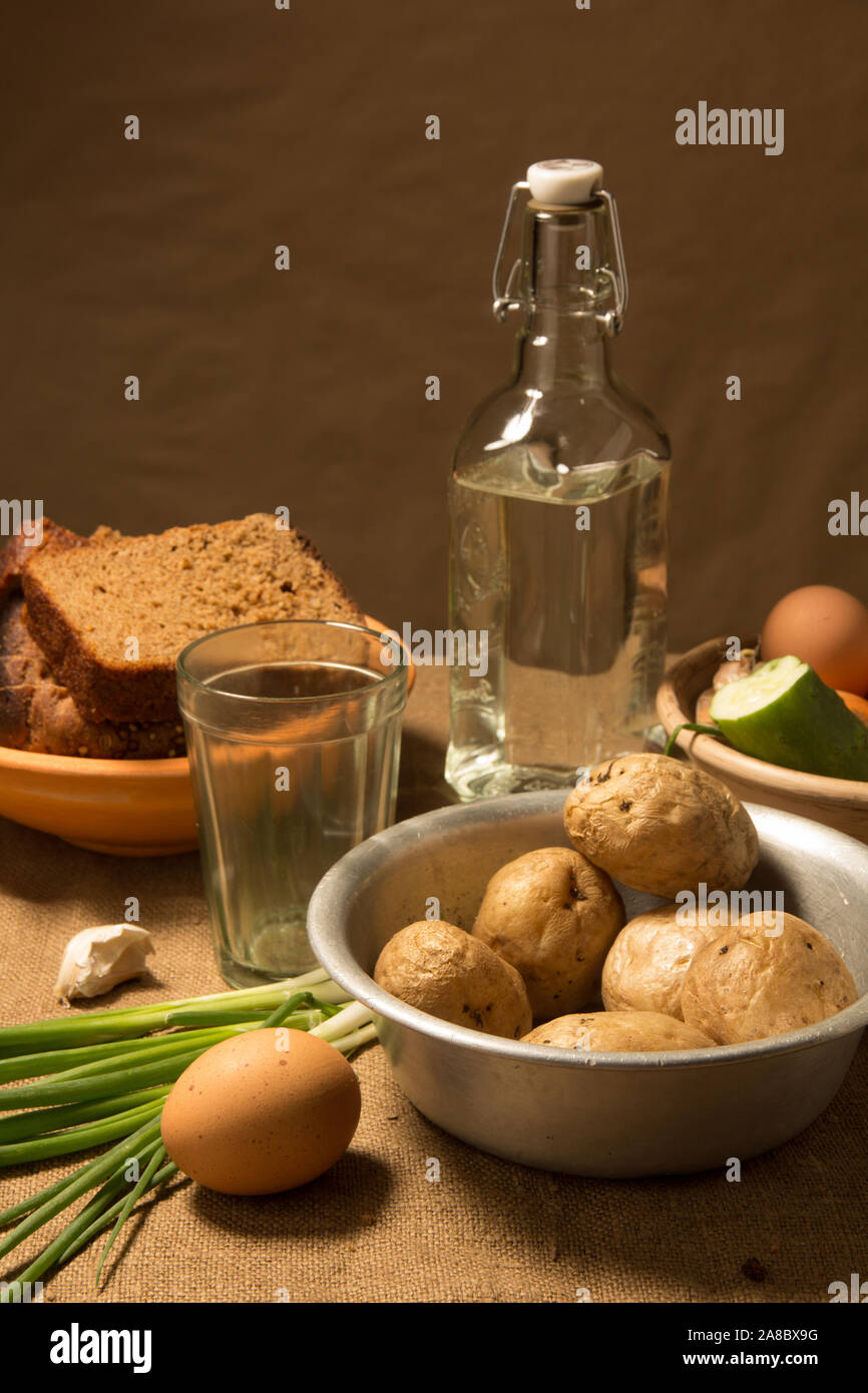 Still Life with a baked potato, bread and vodka Stock Photo - Alamy