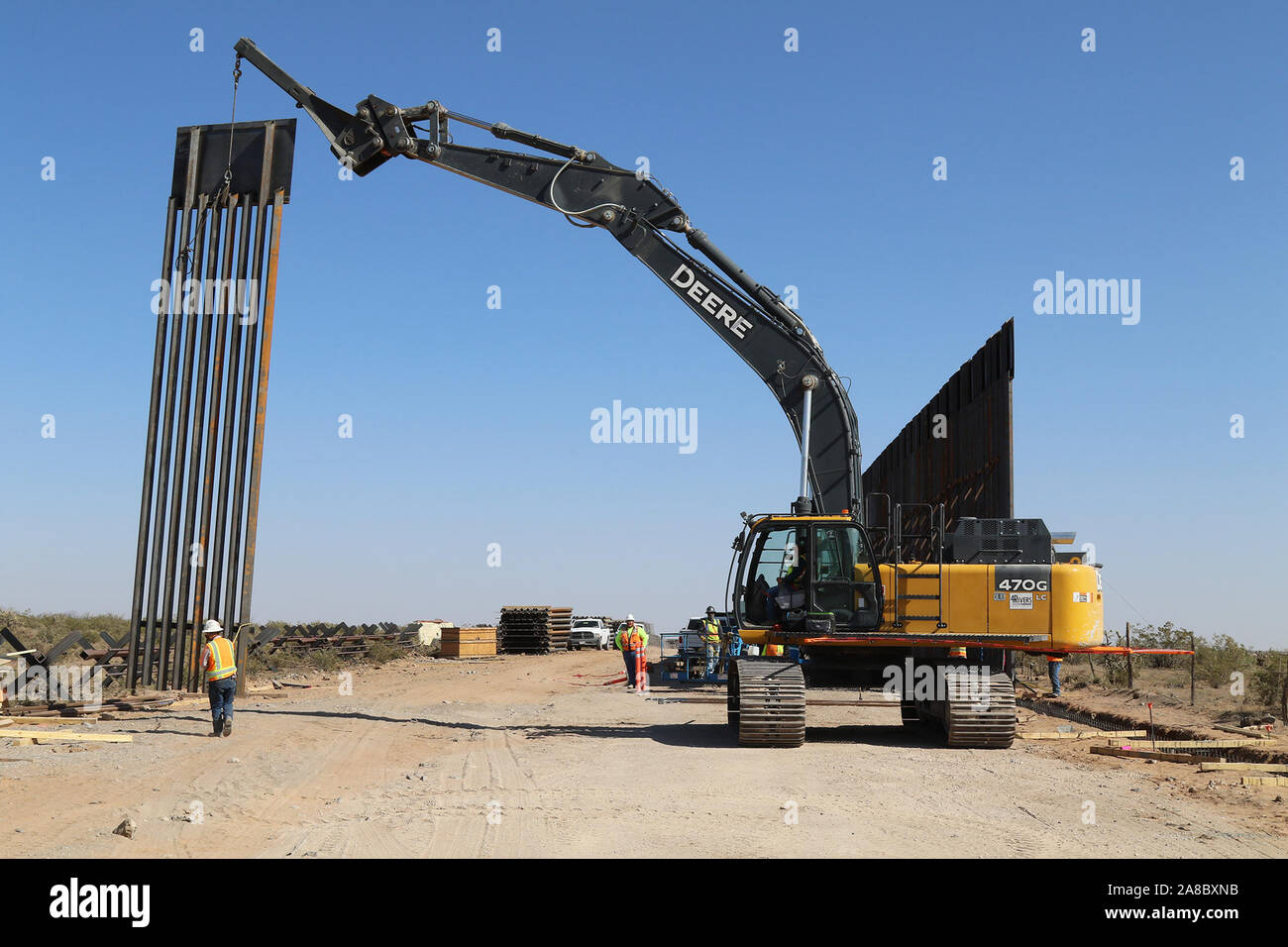 A U.S. Army Corps of Engineers Task Force Barrier contractor lifts a ...