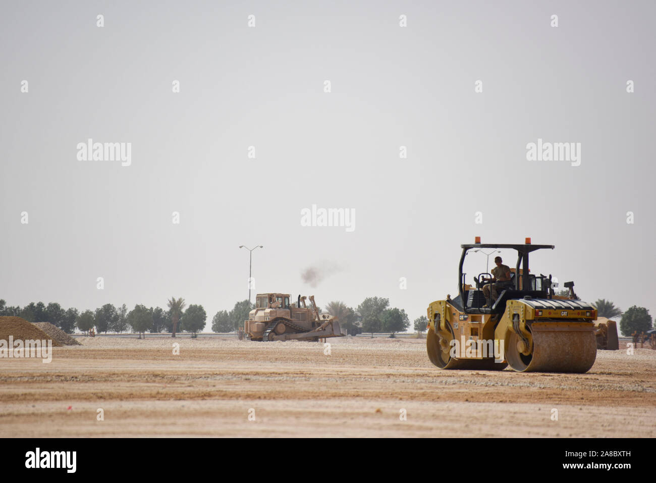 Airmen with the 1st Expeditionary Civil Engineer Group work to level ...