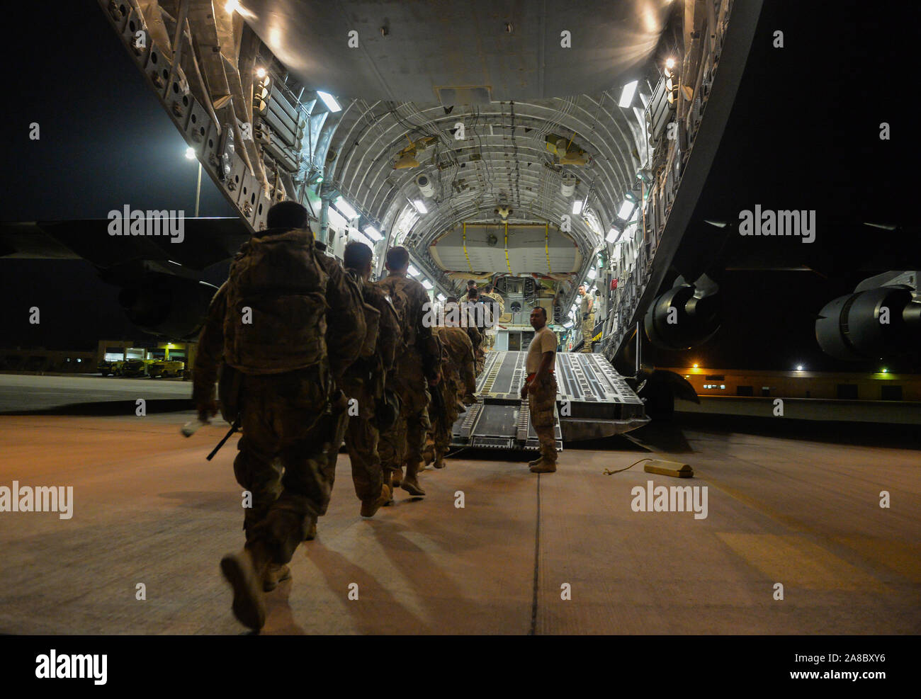 U.S. Army Soldiers with the 4th Infantry Division walk onto a C-17 ...