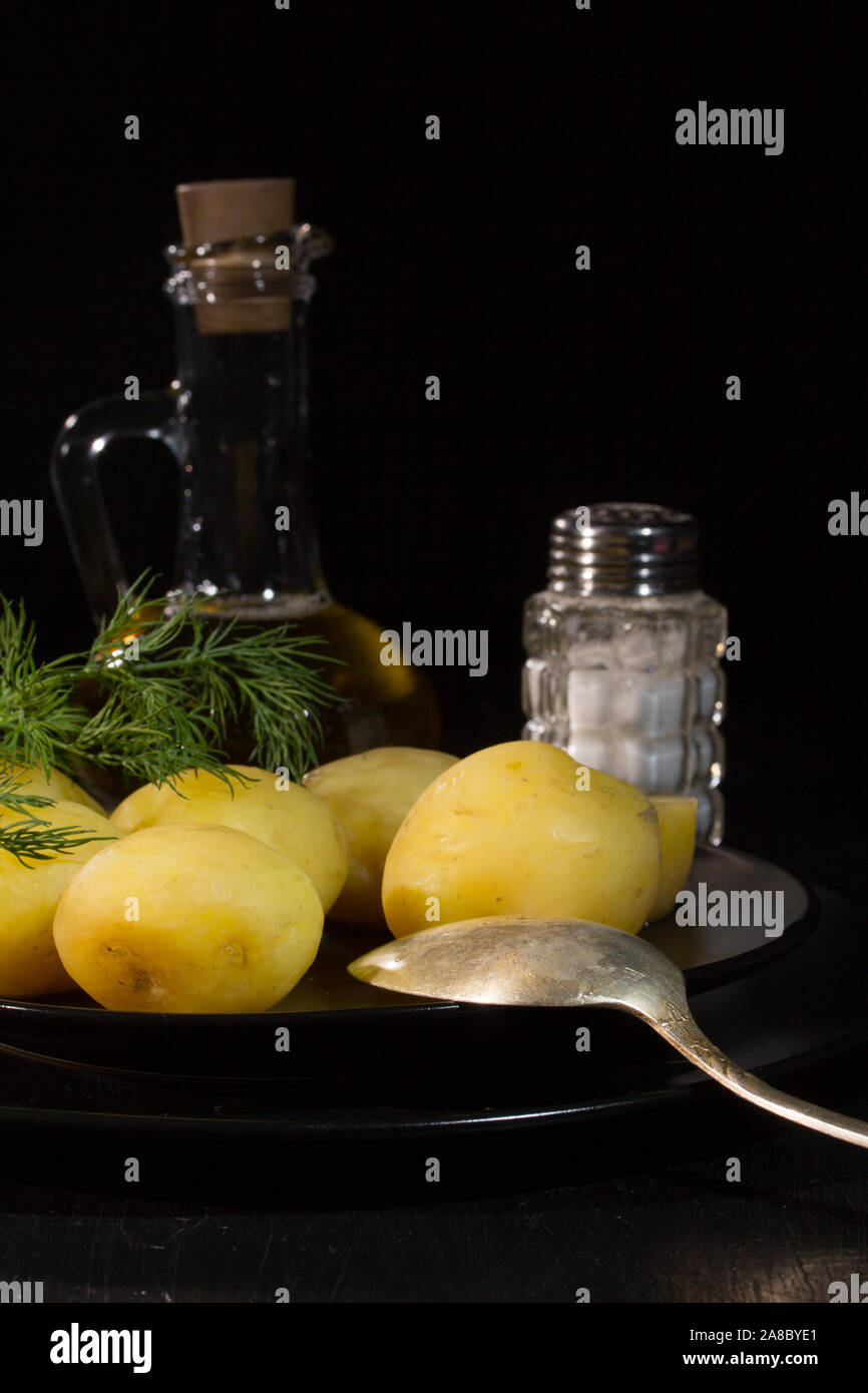 Welded potatoes on a black plate on a dark background Stock Photo - Alamy