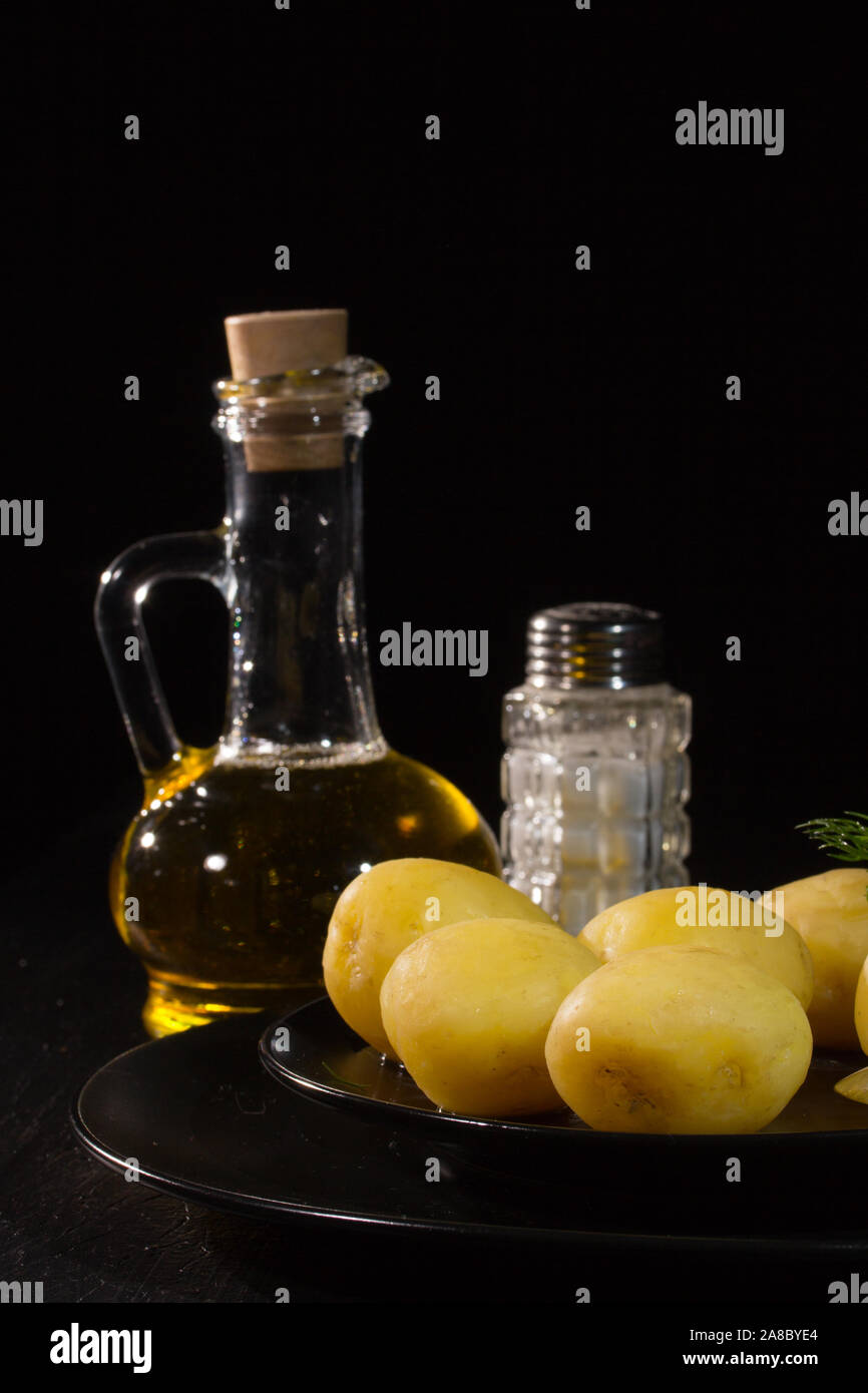 Welded potatoes on a black plate on a dark background Stock Photo - Alamy