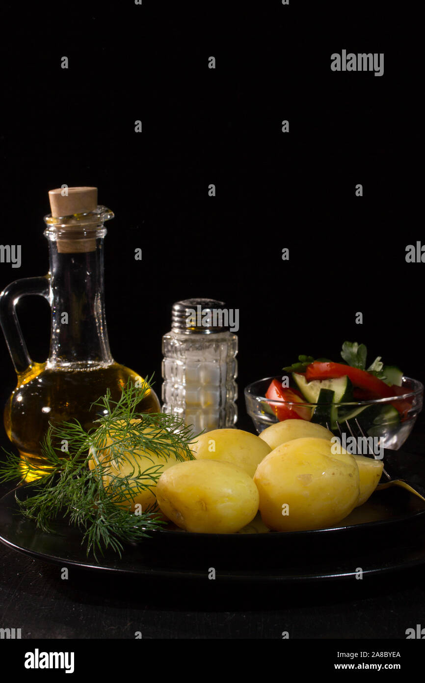 Welded potatoes on a black plate on a dark background Stock Photo - Alamy