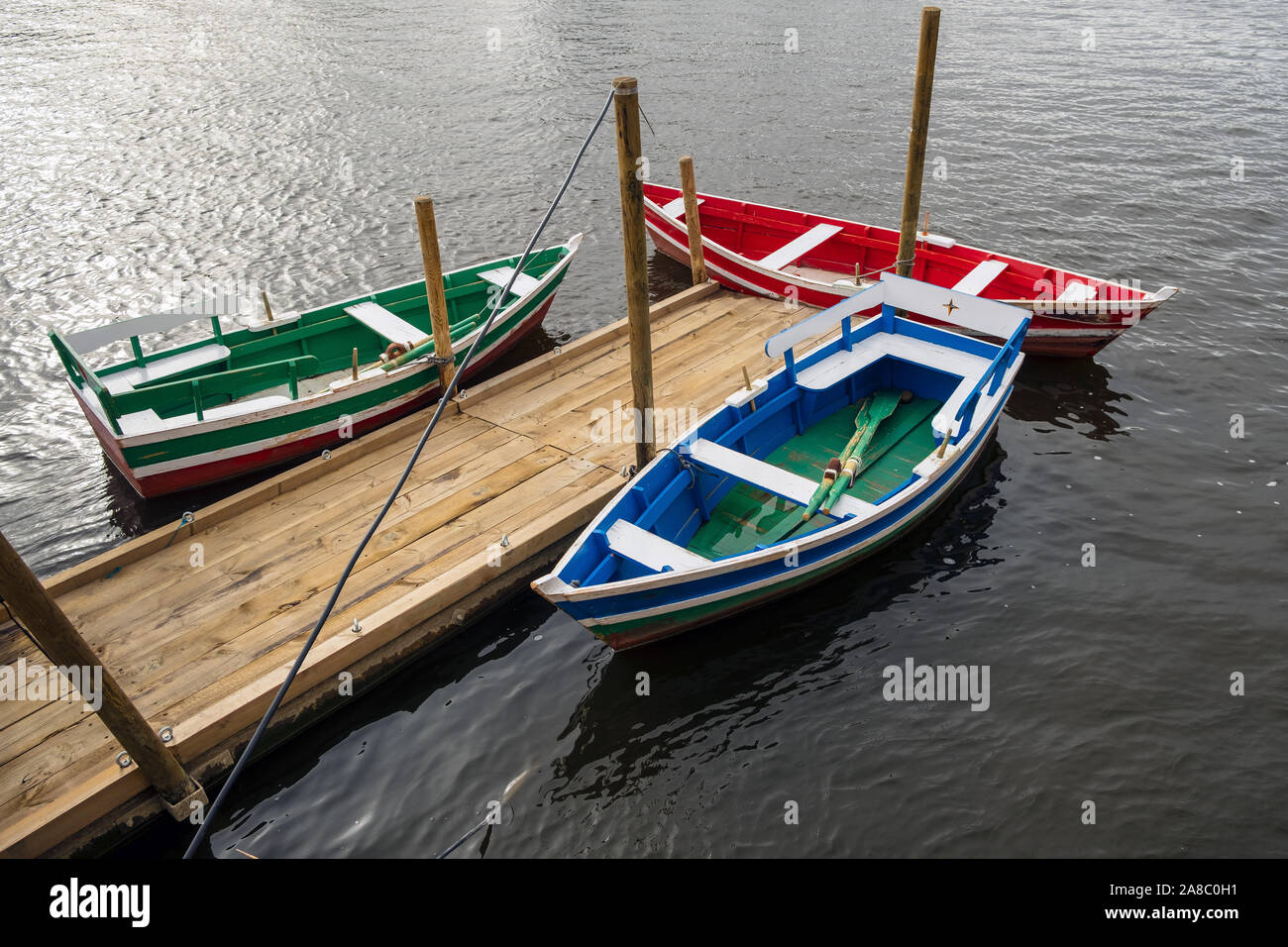 colorful rowing boats on a jetty Stock Photo - Alamy