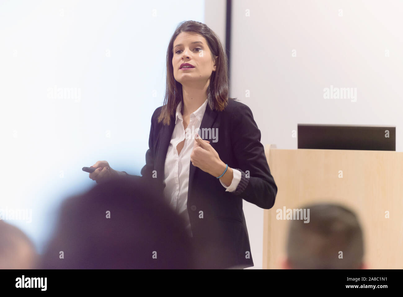 Pretty young businesswoman, teacher or mentor coach speaking to young ...