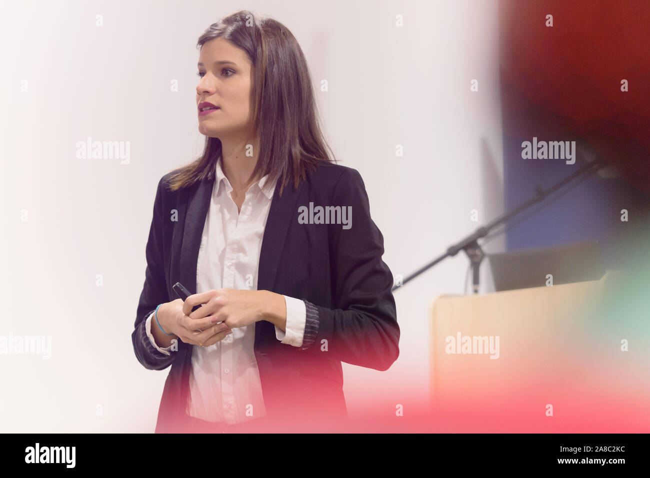 Pretty young businesswoman, teacher or mentor coach speaking to young ...