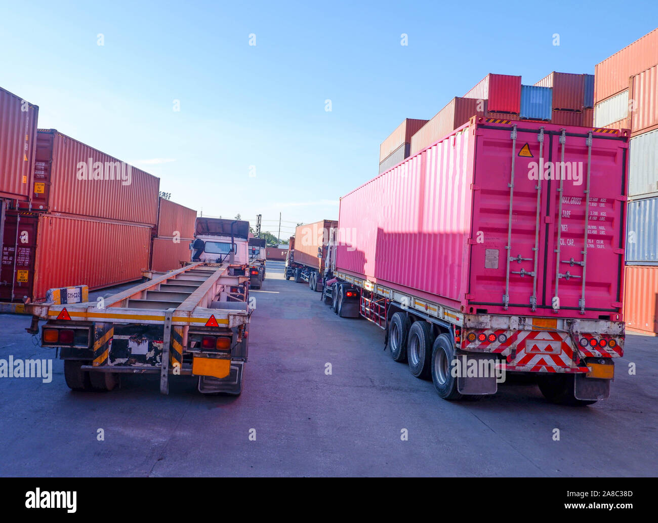 Trucks come to wait for containers in the boat Stock Photo - Alamy
