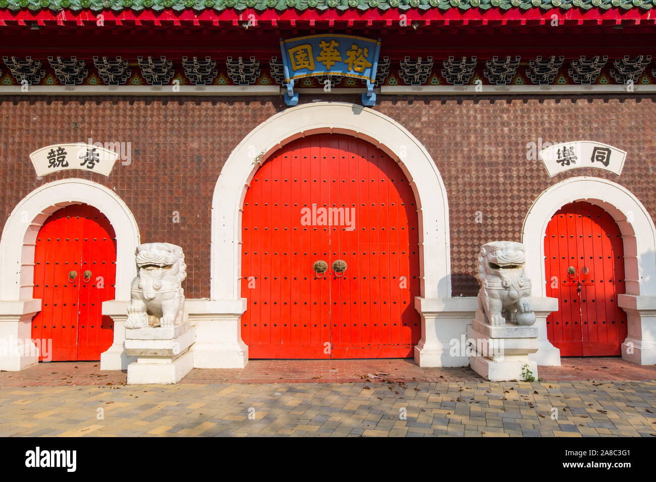Traditional arch design with three red doors Stock Photo - Alamy