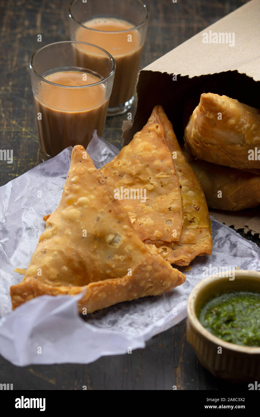Samosa and hot tea or chai snack Stock Photo - Alamy