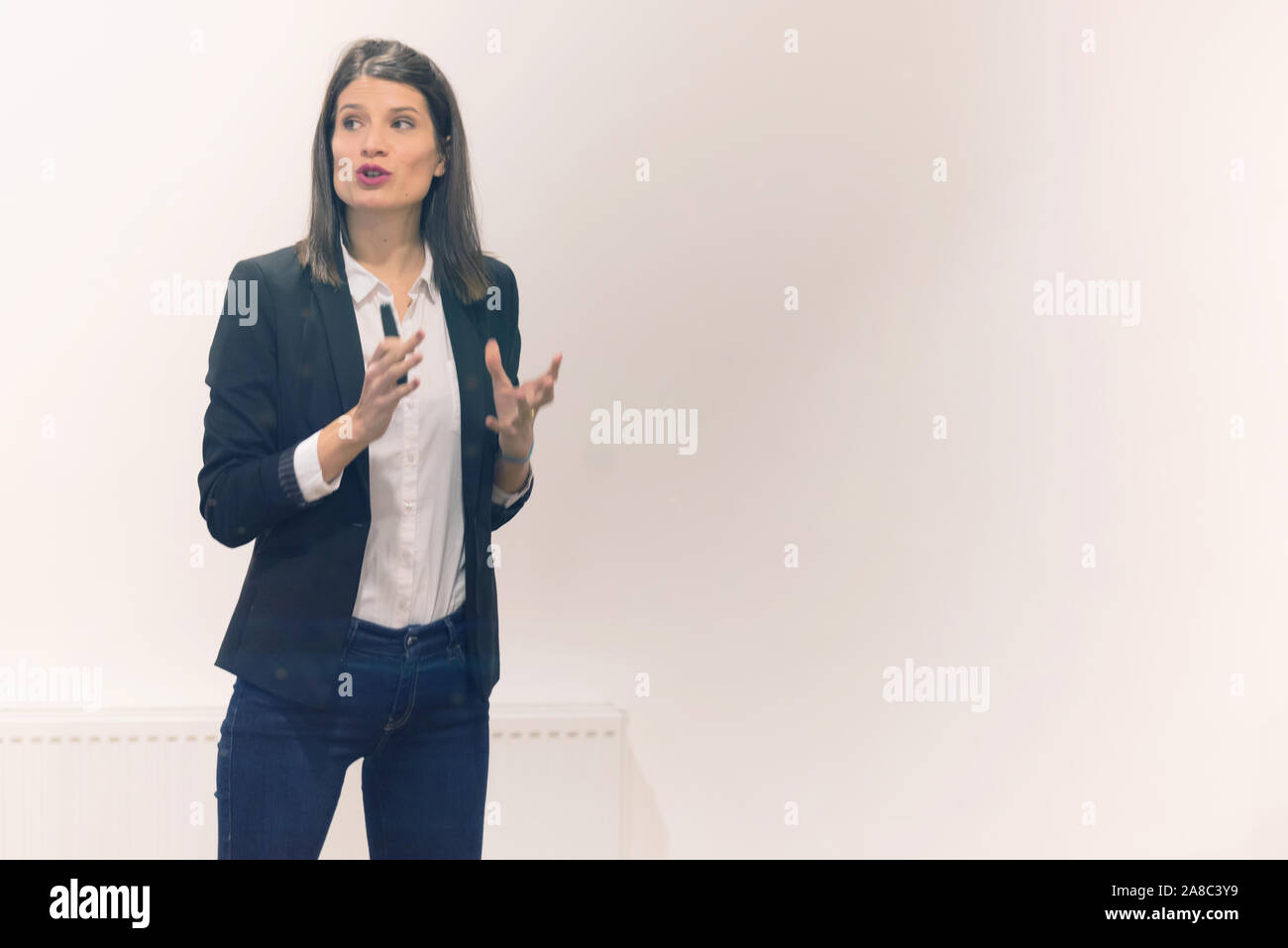 Pretty young businesswoman, teacher or mentor coach speaking to young ...