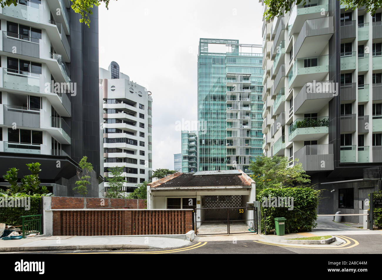 A small run down old private property house sitting in-between tall the ...