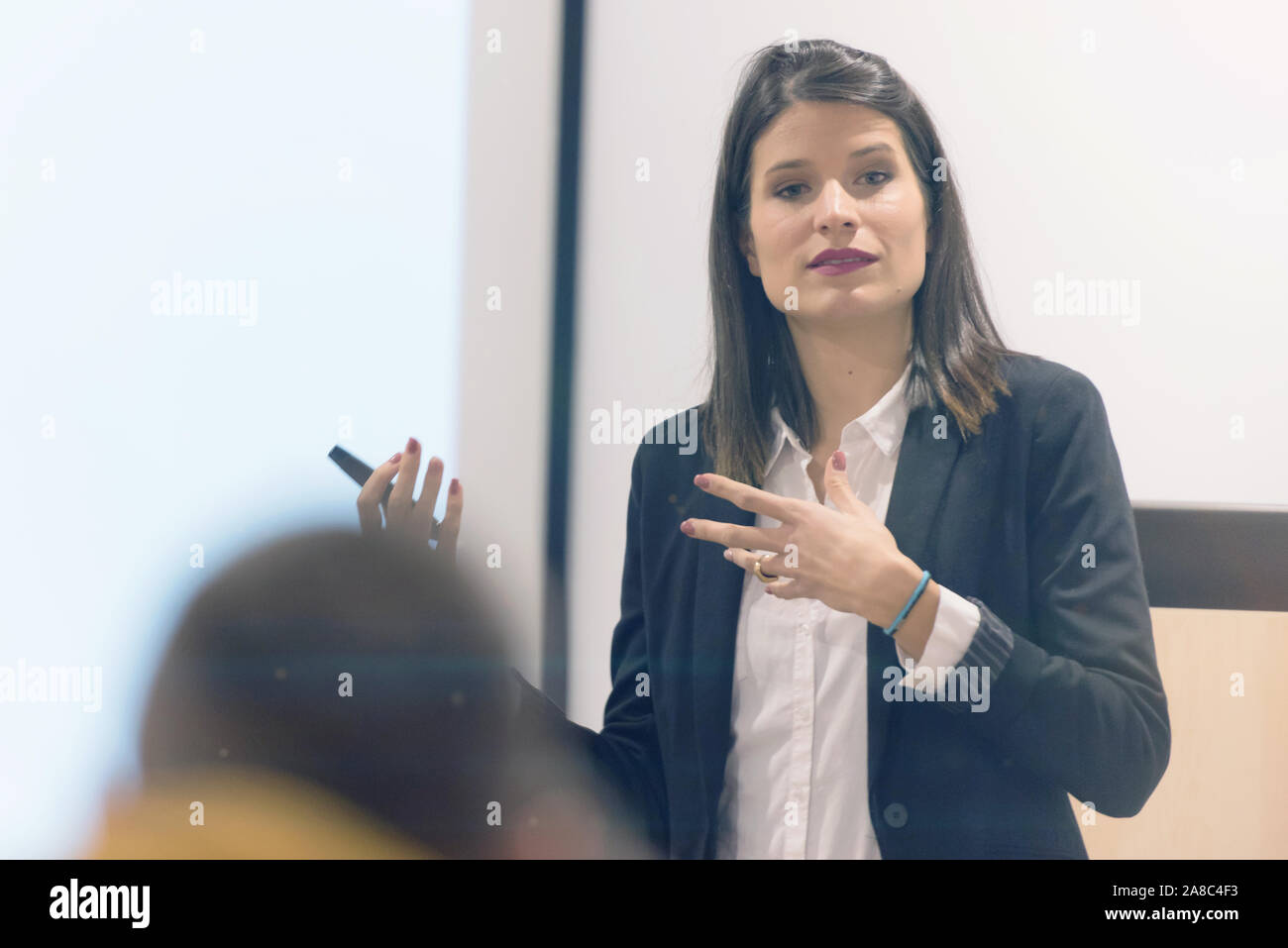 Pretty young businesswoman, teacher or mentor coach speaking to young ...