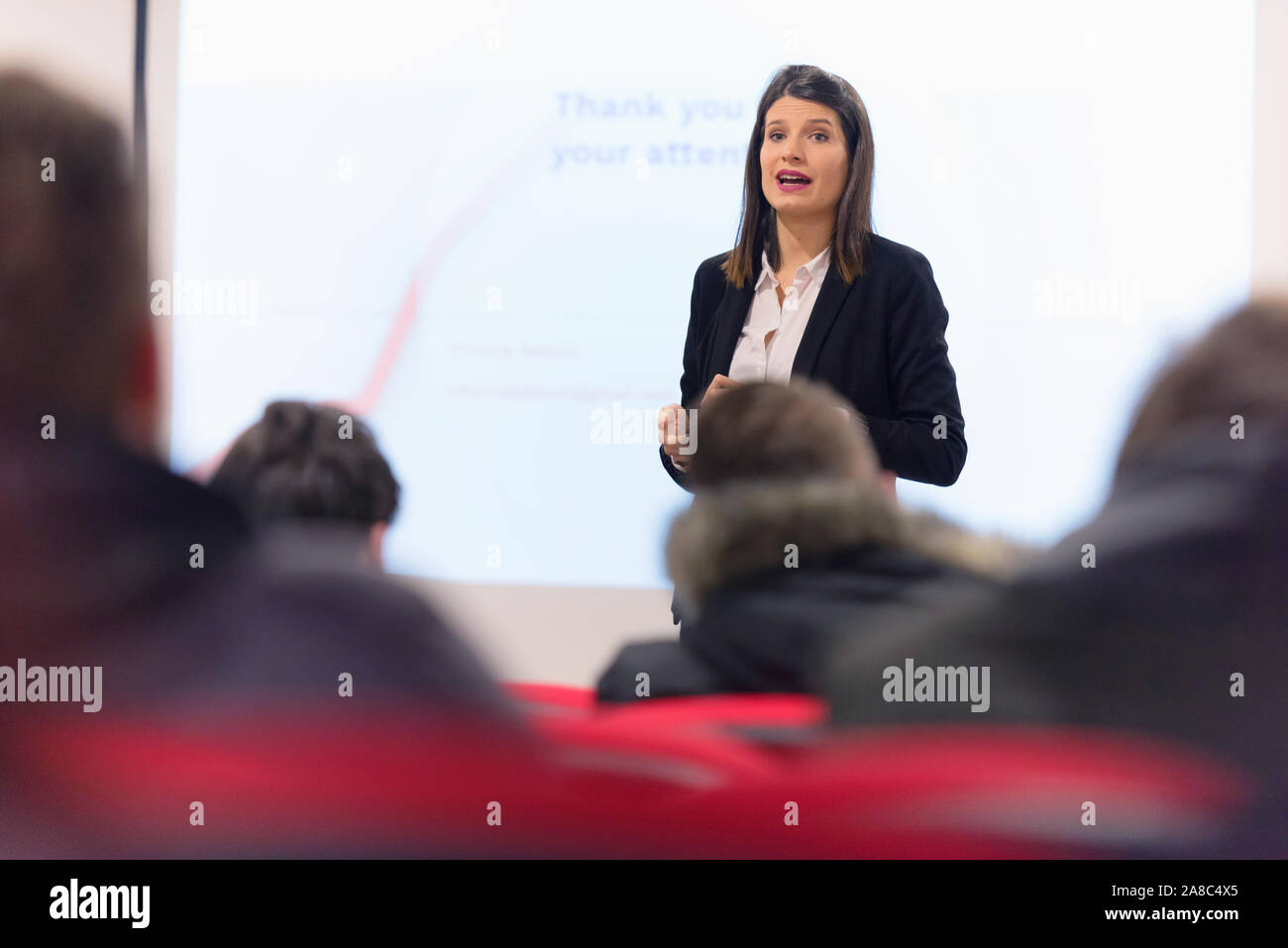 Pretty young businesswoman, teacher or mentor coach speaking to young ...