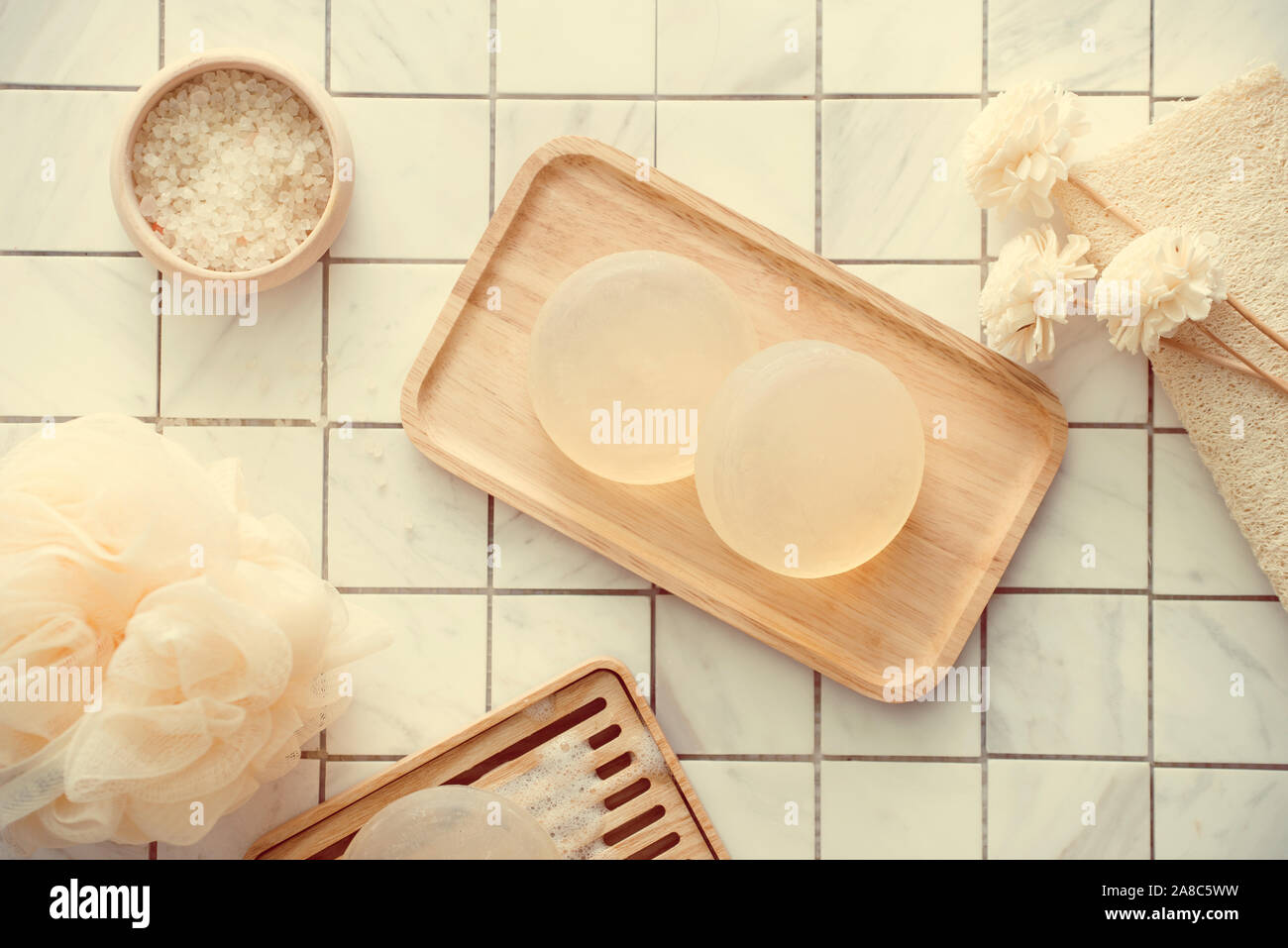 Natural soap and salt on a wooden board, hygiene items for bath and spa ...