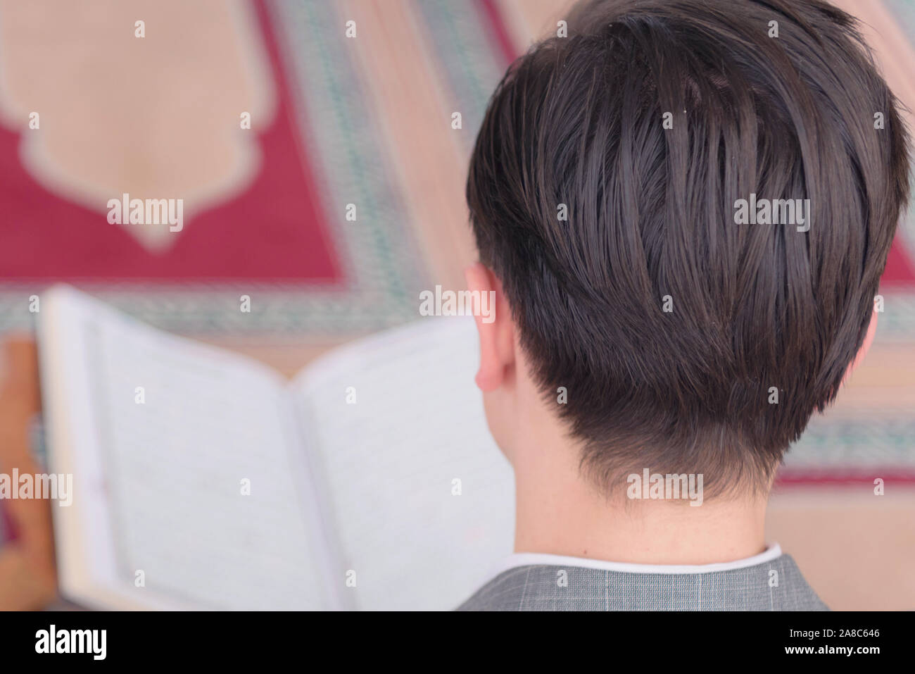 Religious young hafiz muslim man praying inside the mosque and reading ...