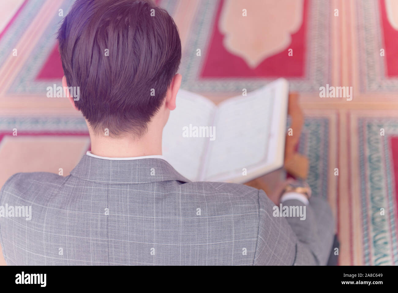 Religious young hafiz muslim man praying inside the mosque and reading ...