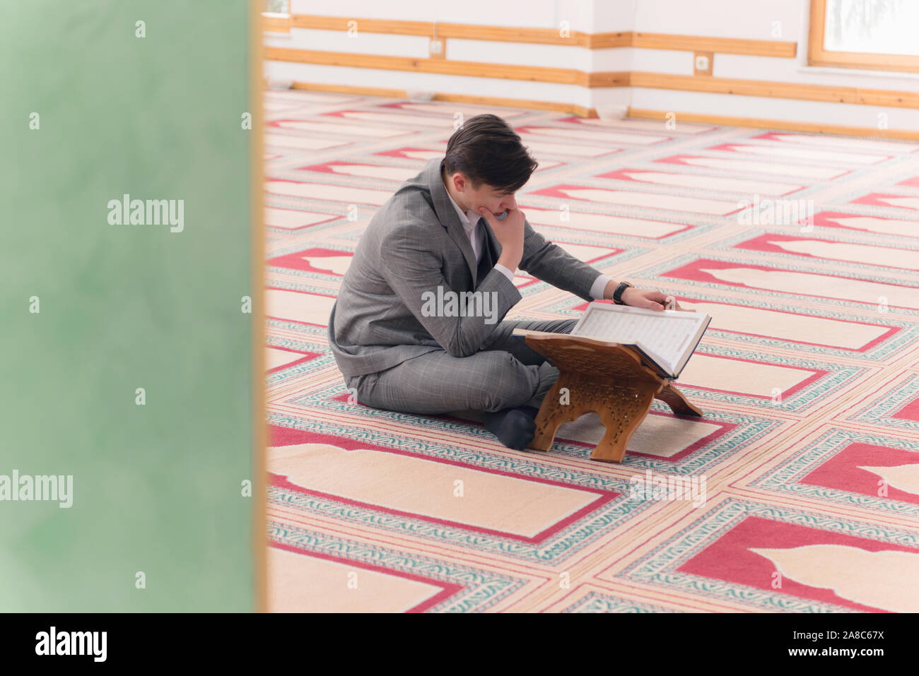 Religious young hafiz muslim man praying inside the mosque and reading ...