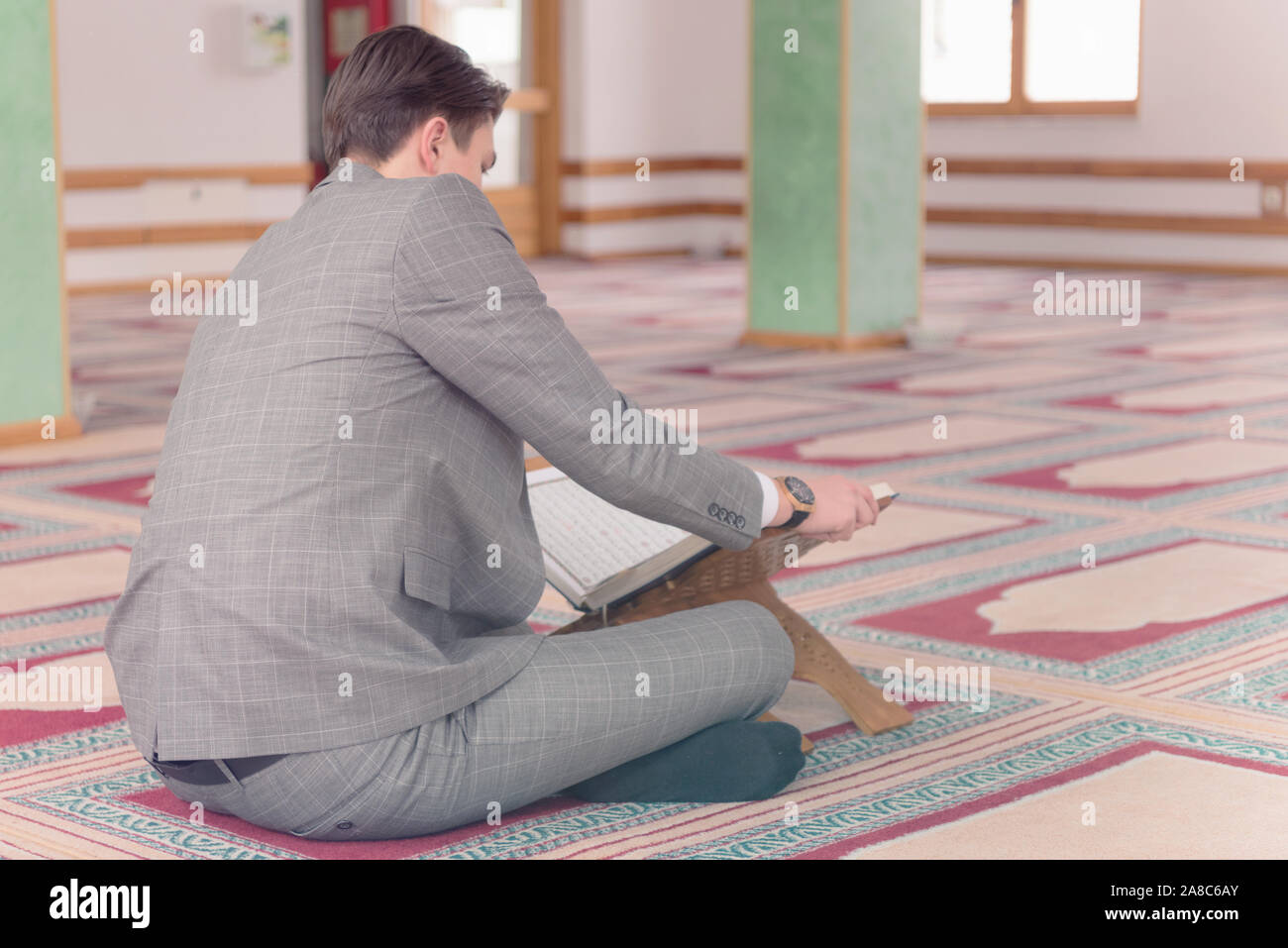 Religious young hafiz muslim man praying inside the mosque and reading ...