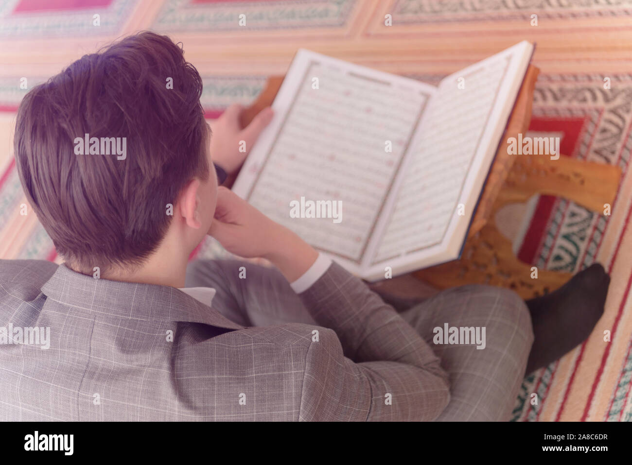 Religious young hafiz muslim man praying inside the mosque and reading ...