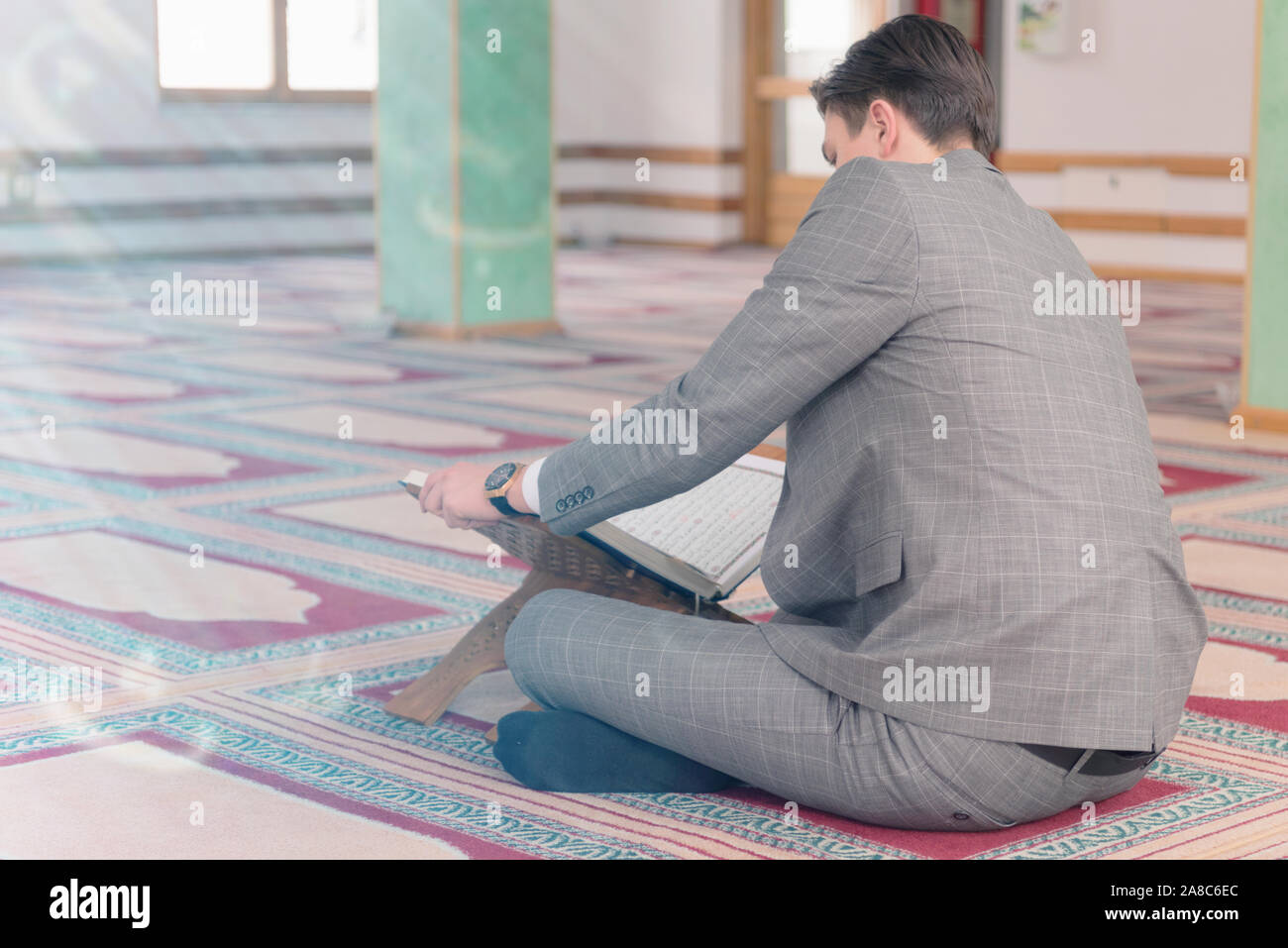 Religious young hafiz muslim man praying inside the mosque and reading ...