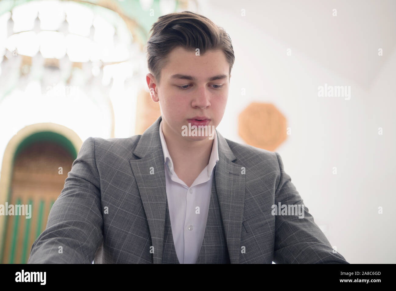 Religious young hafiz muslim man praying inside the mosque and reading ...