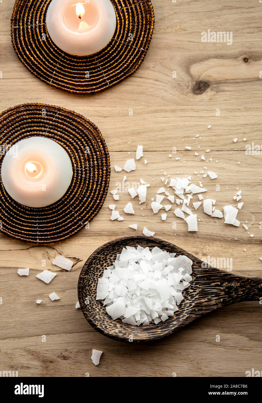 Magnesium Chloride Flakes scattered around brown wooden spoon on ...