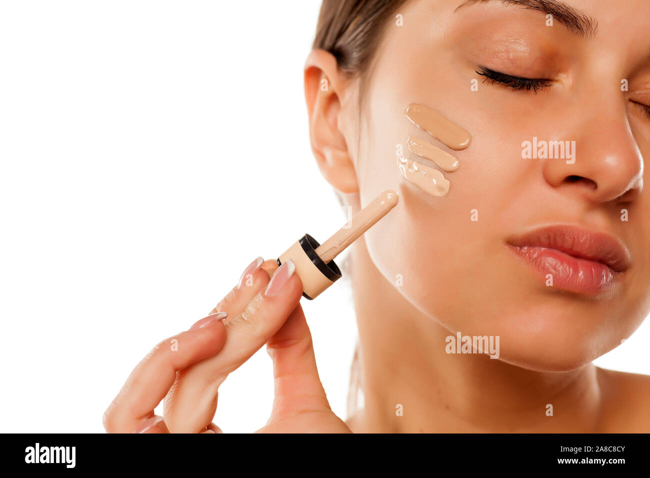 A young woman applied with a pipette three different shades of ...