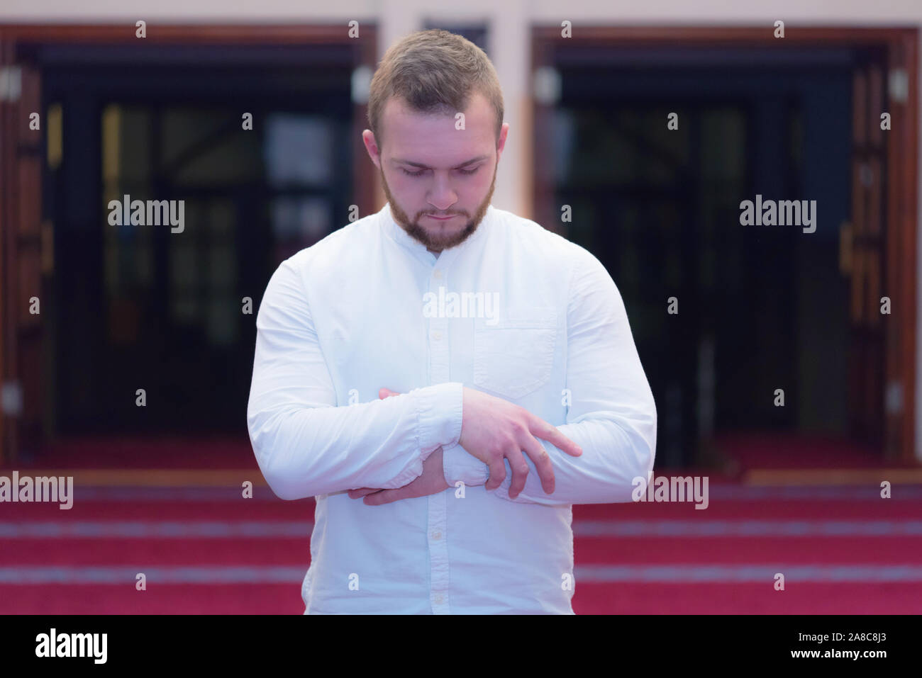 Young religious european muslim man praying inside the beautiful big ...