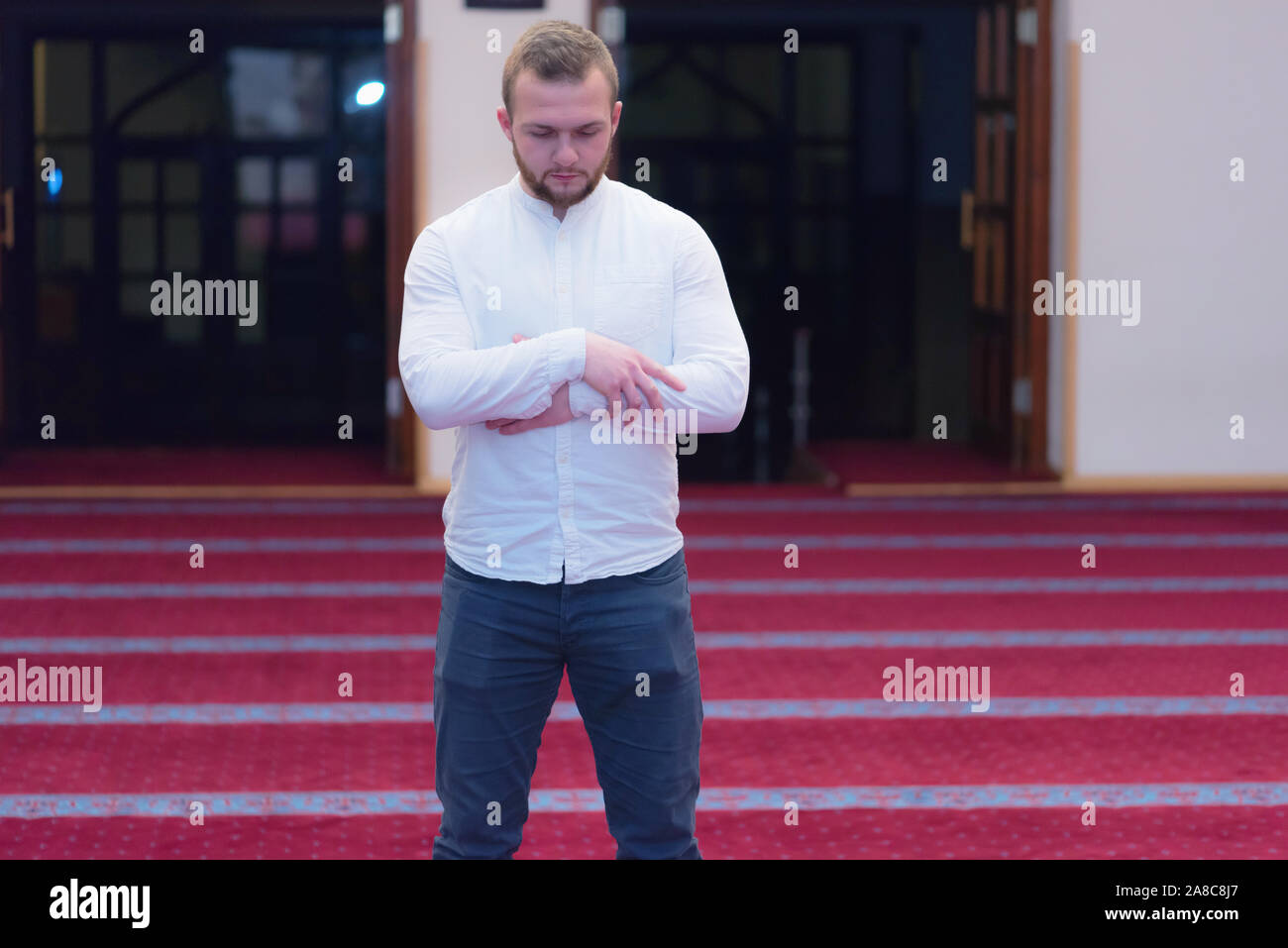 Young religious european muslim man praying inside the beautiful big ...