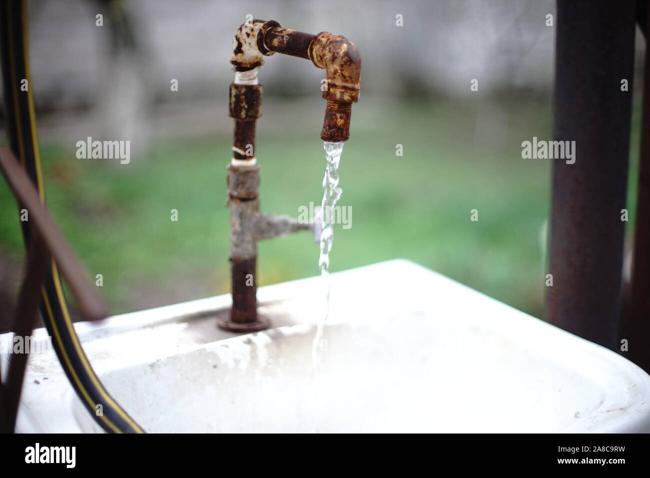 Old rusty tap on a sink with flowing water in a rural yard Stock Photo ...