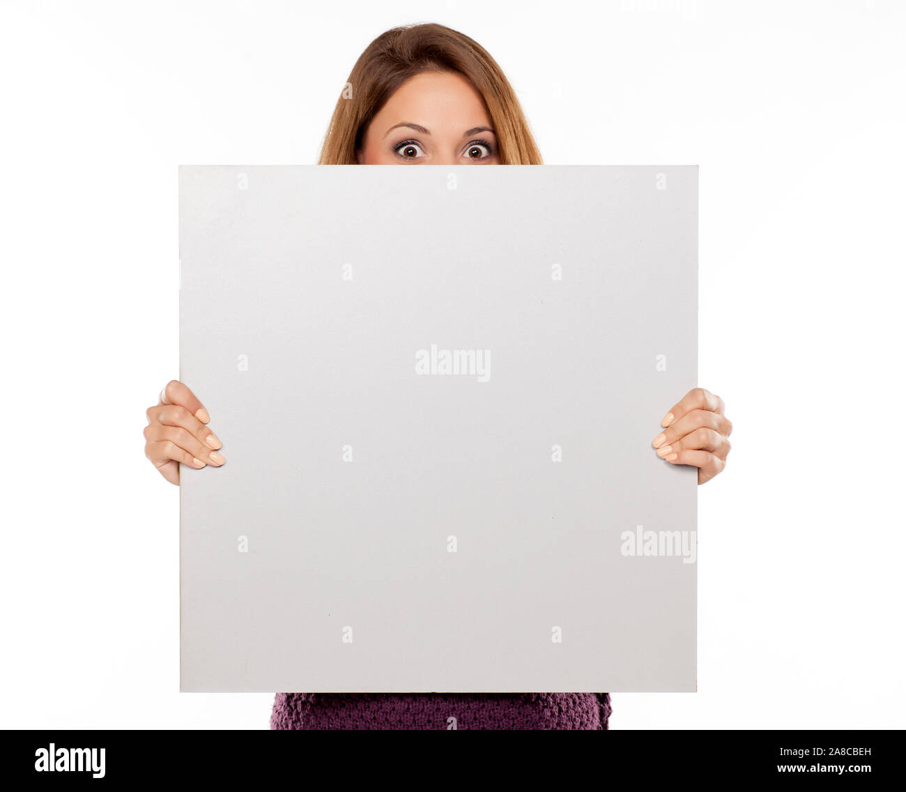 Beautiful young woman peeking behind hi-res stock photography and ...