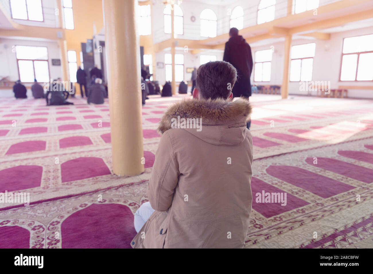 Religious muslim prayers praying together inside the big mosque Stock ...