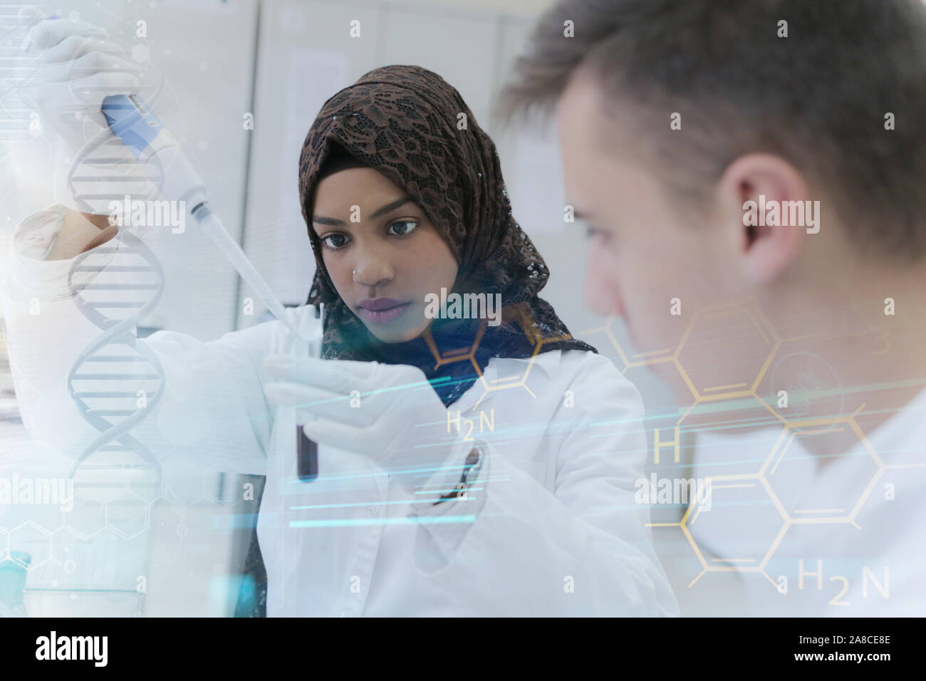 Two young male and female multiethnic, mixed race students scientists ...