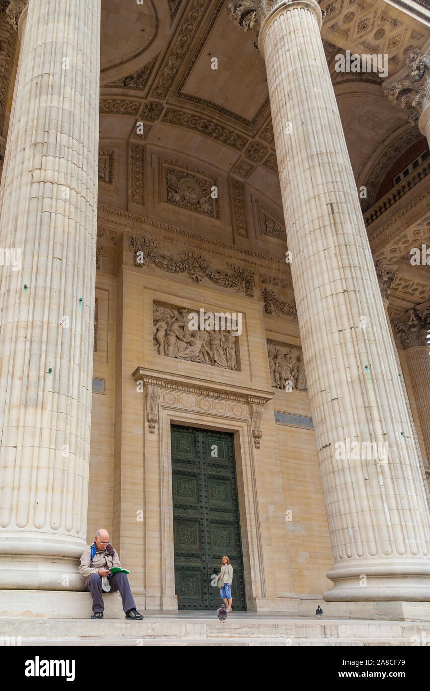 An old man sits at the base of a Corinthian column in the peristyle in ...