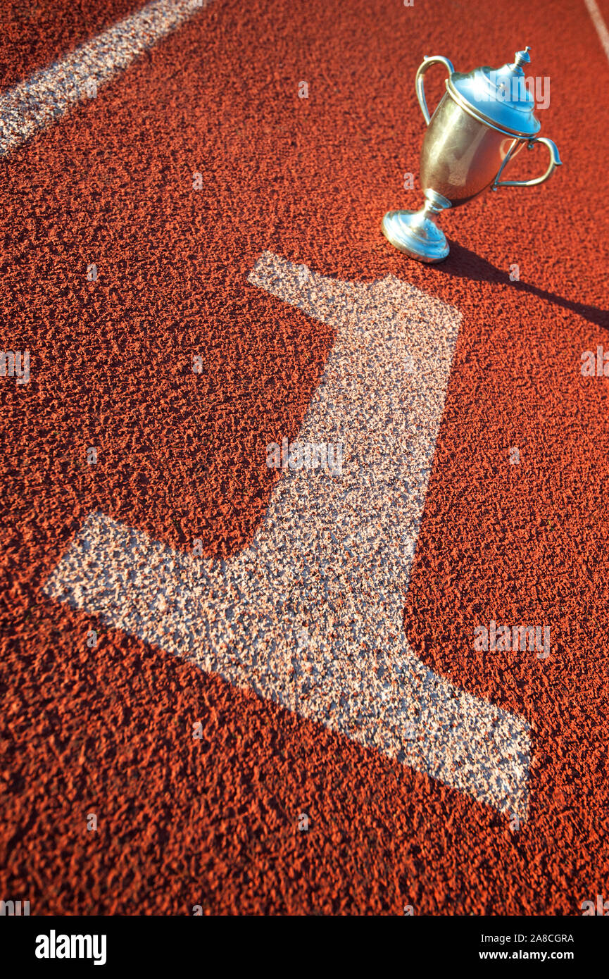 Large silver trophy standing next to the number one lane on a ...