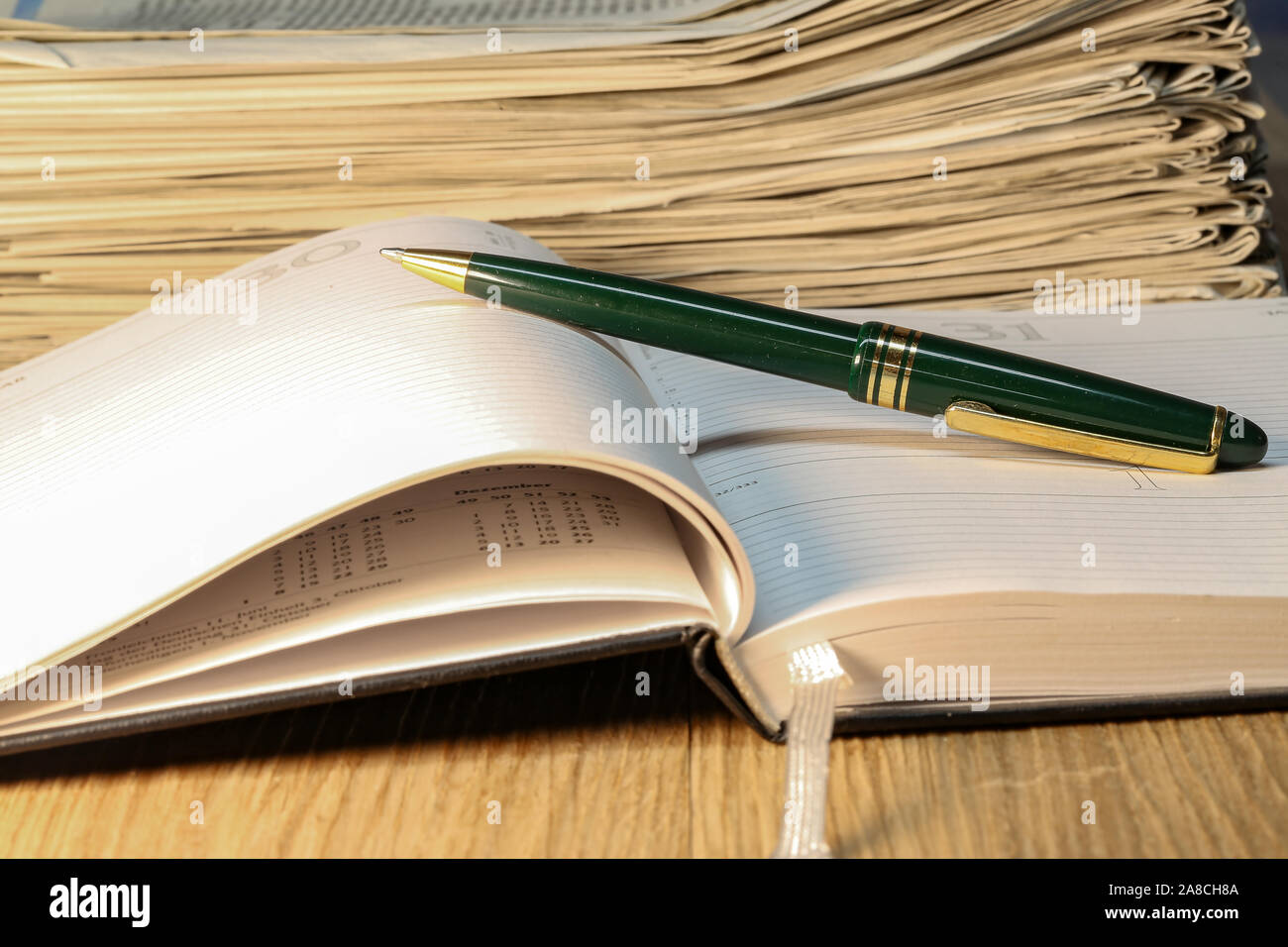 Pen lying on calendar or organizer on desk in office Stock Photo - Alamy