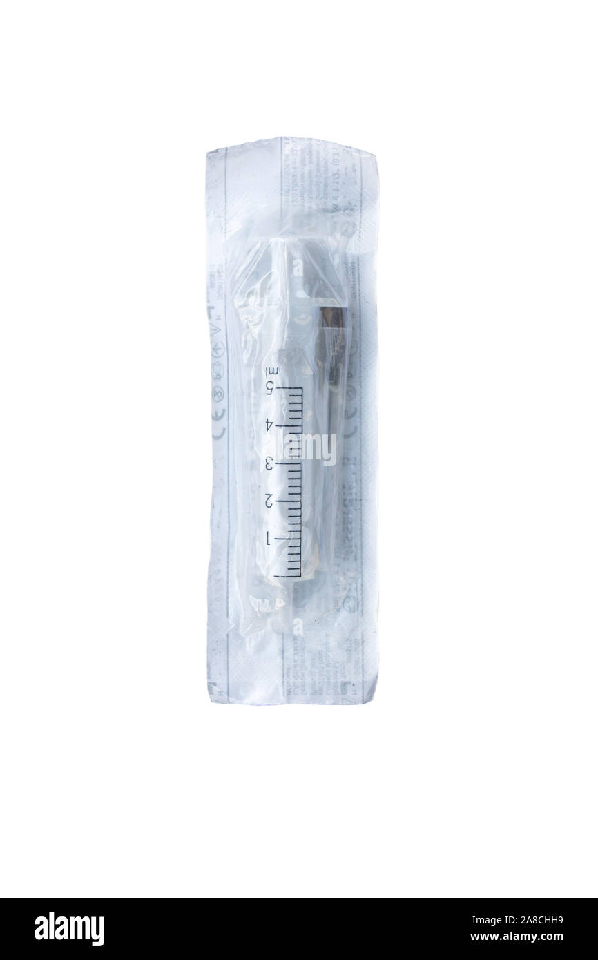 disposable plastic syringe with a needle in the package on a white ...