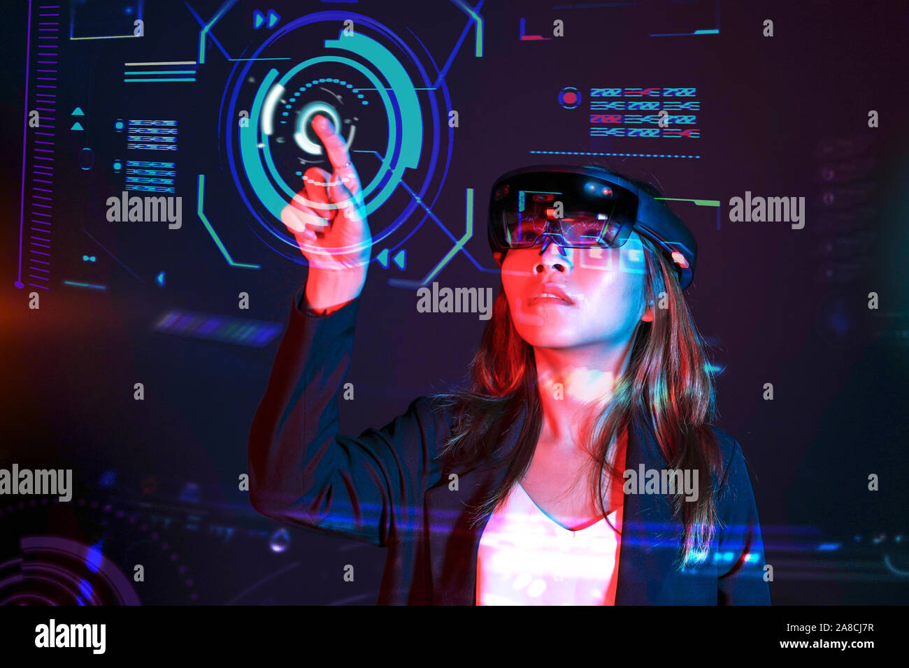 Young asian girl try augmented and virtural reality glasses hololens in ...