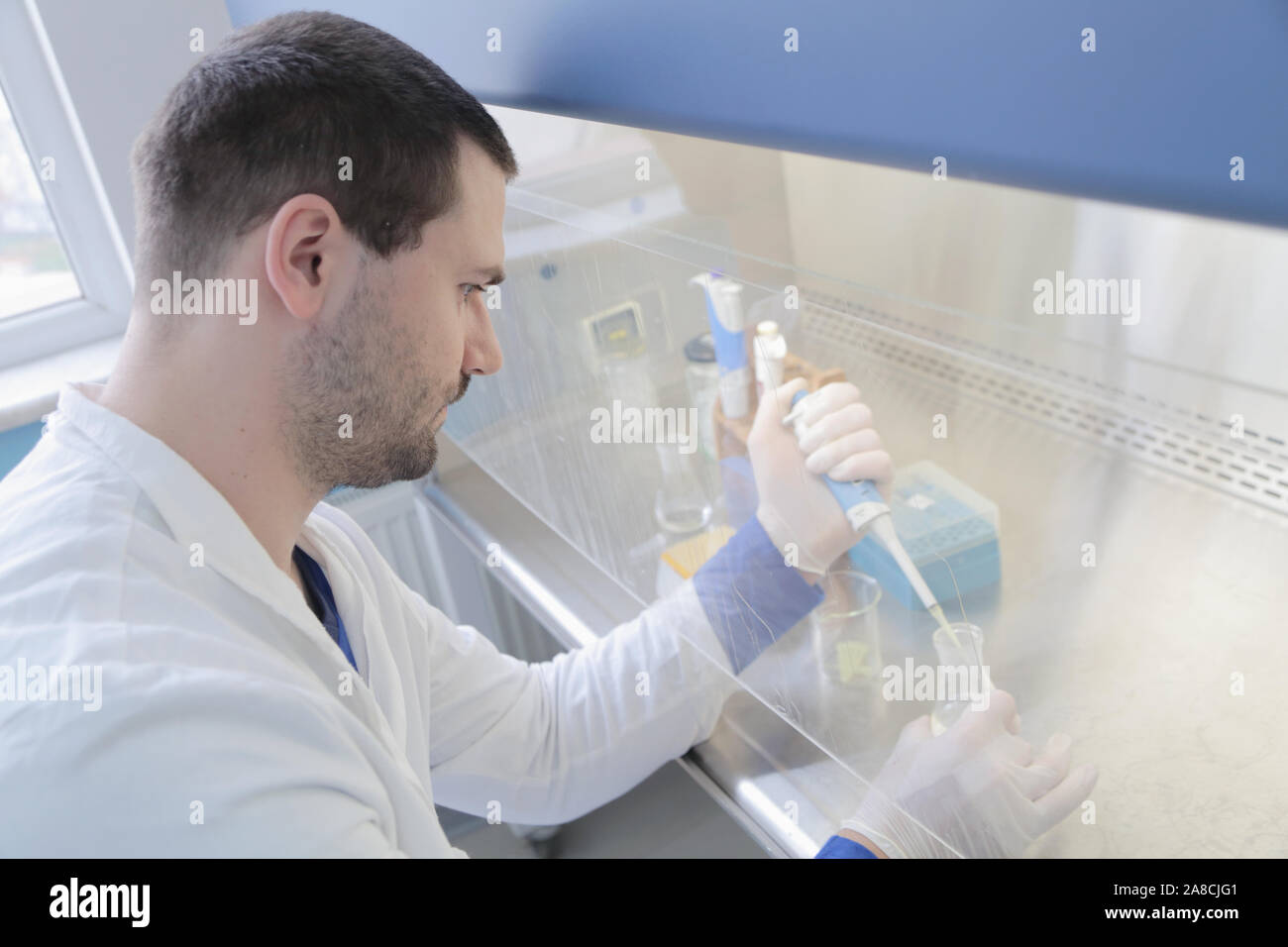 Young male Laboratory scientist working at lab with test tubes and ...