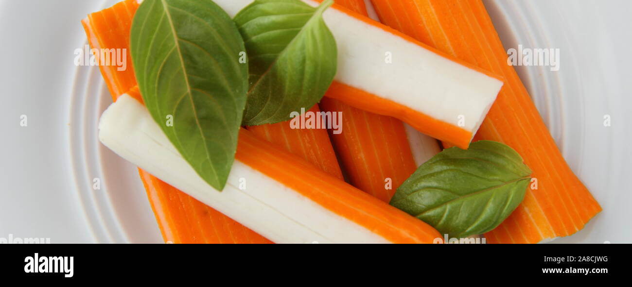 six fresh surimi with a leaf of basil on a plate Stock Photo - Alamy