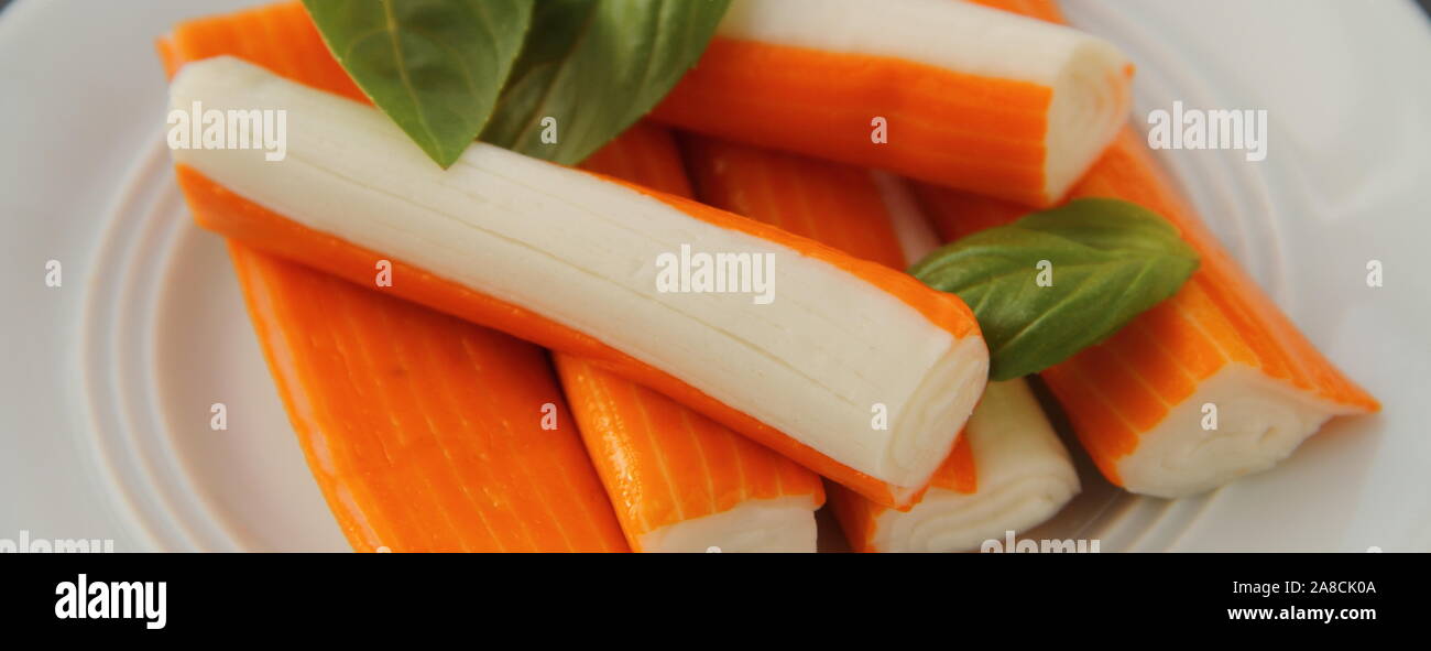 six fresh surimi with a leaf of basil on a plate Stock Photo - Alamy