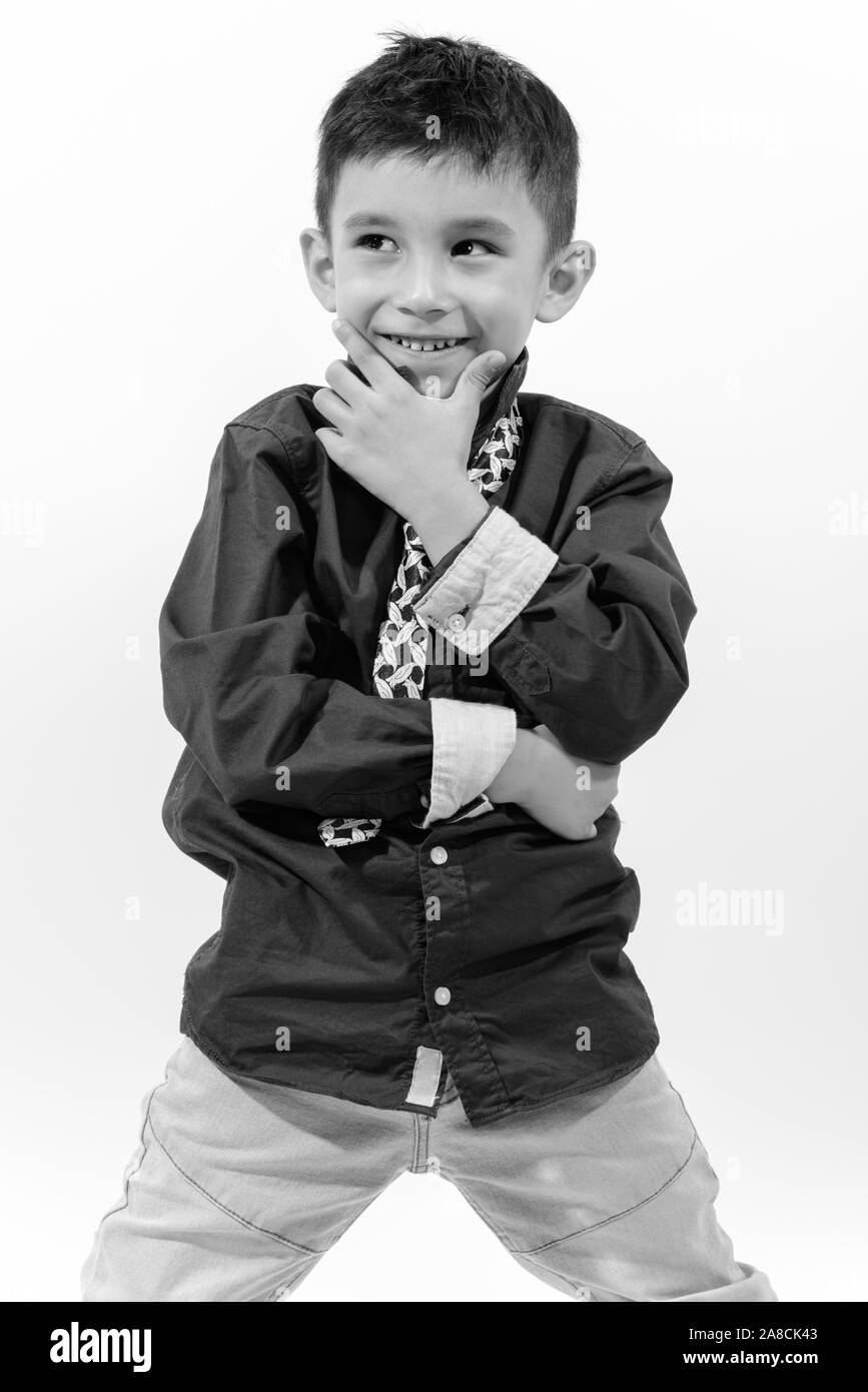 Studio shot of cute happy boy smiling and thinking Stock Photo - Alamy