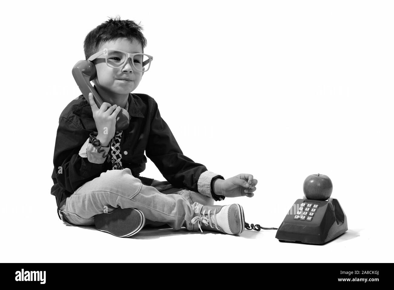 Studio shot of cute boy talking on old telephone Stock Photo - Alamy