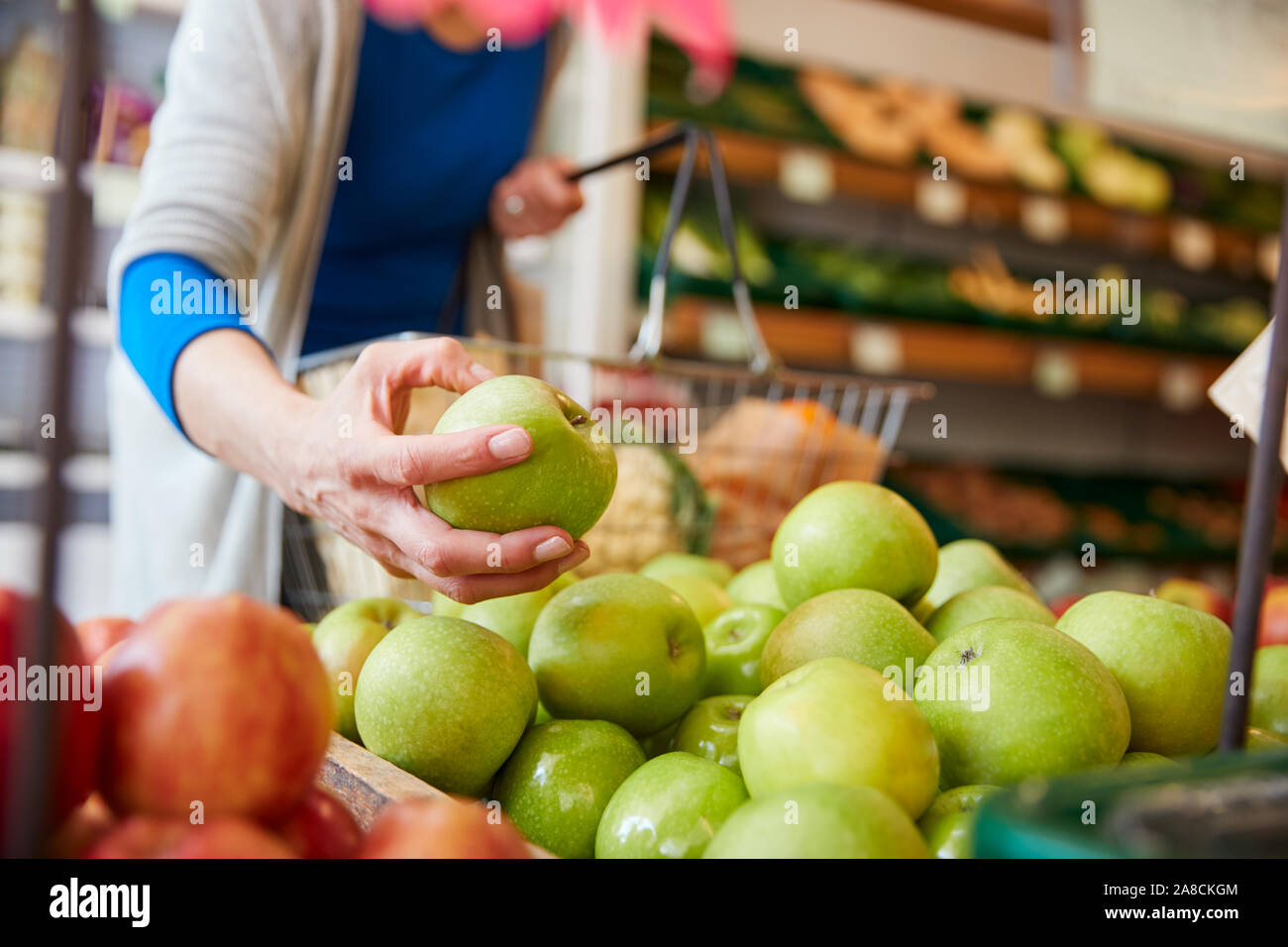 Close Up Of Woman Customer With Basket Buying Fresh Apples In Organic ...