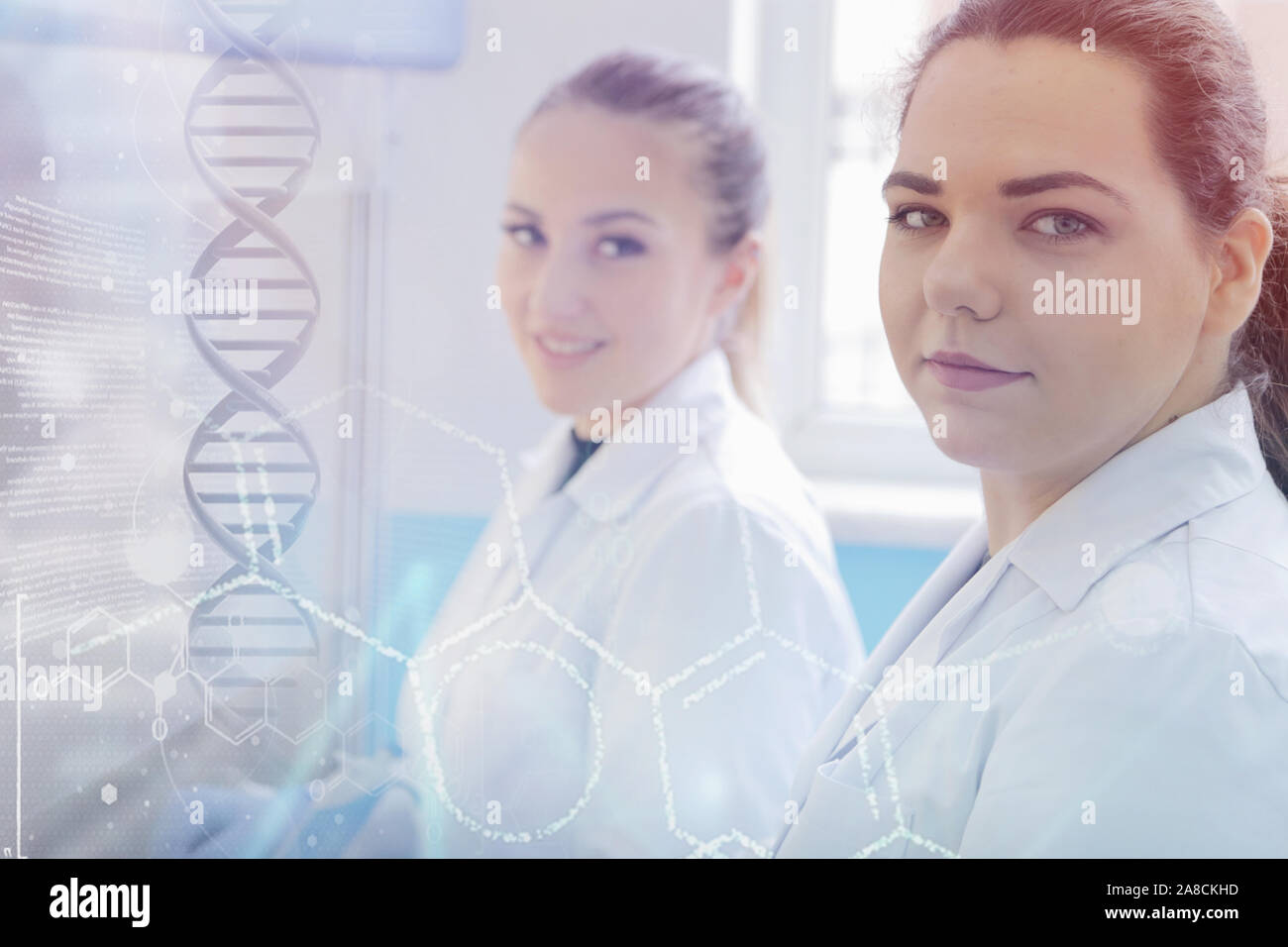 Two young female Laboratory scientists working at lab with test tubes ...
